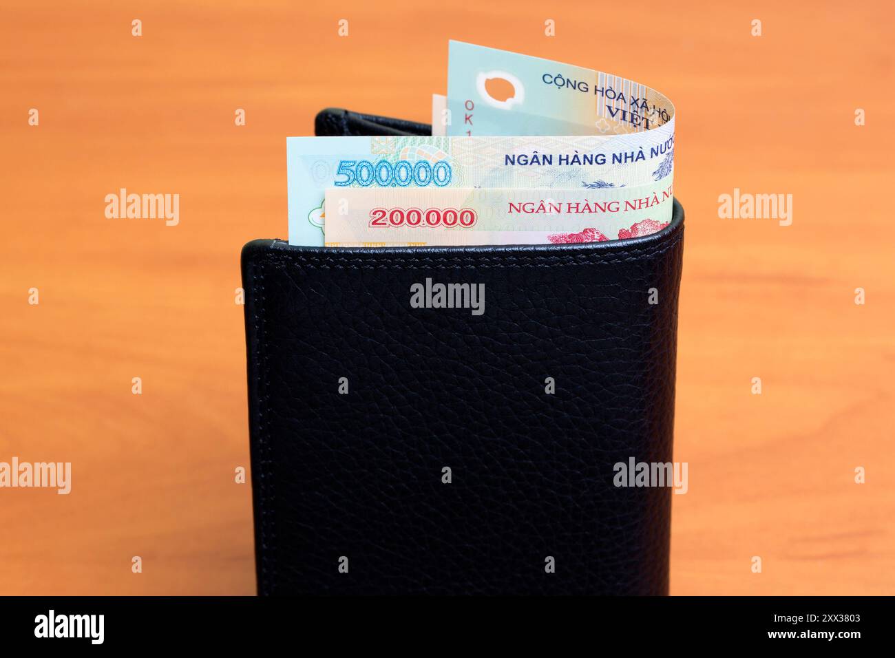 Vietnamese money - dong in the black wallet Stock Photo - Alamy
