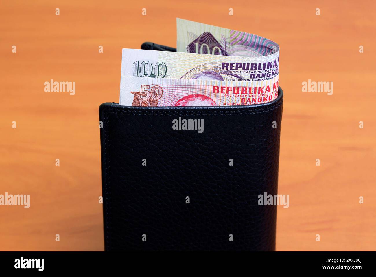 Philippine money - peso in the black wallet Stock Photo - Alamy