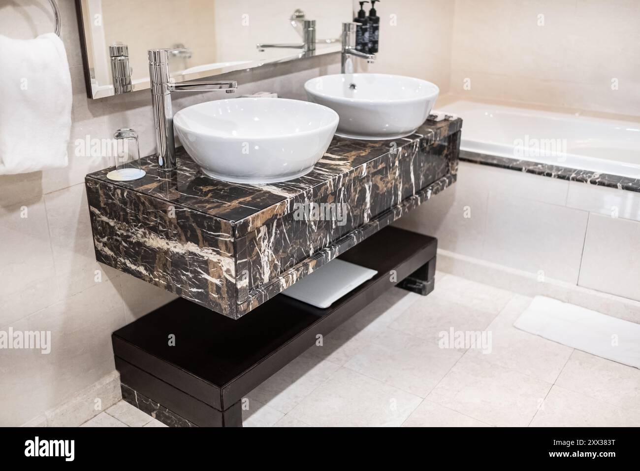 Bathroom modern vanity unit with two round ceramic sinks. A ...
