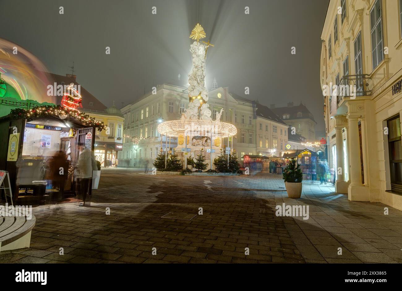 Plague column illuminated for Christmas in Baden, Austria Stock Photo ...