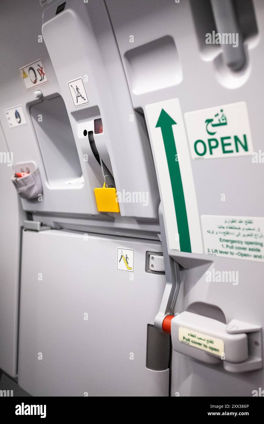 An emergency door in the aircraft cabin. Passenger airplane entrance ...