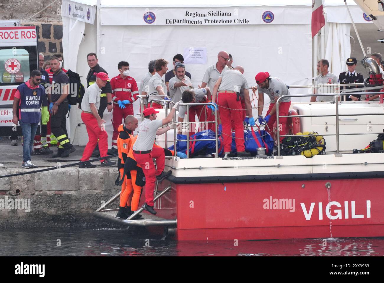 The fifth body bag is brought ashore at the harbour in Porticello by ...