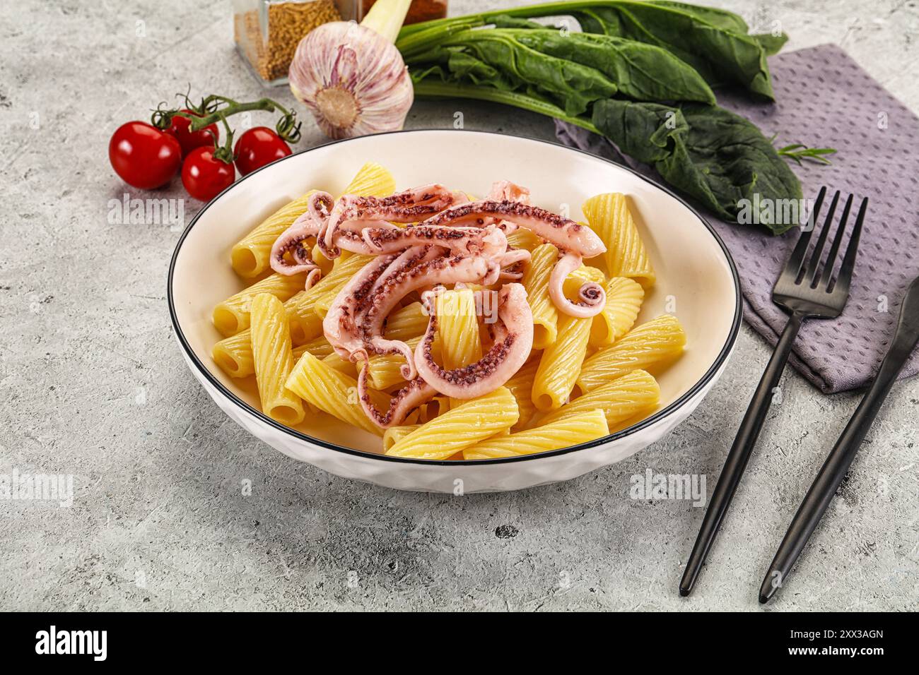 Italian cuisine - pasta tortiglioni with squid tentacles Stock Photo ...