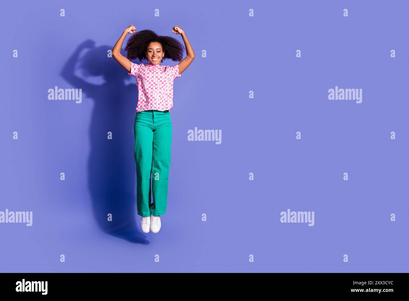 Full size photo of pretty young girl jump flexing muscles wear trendy ...