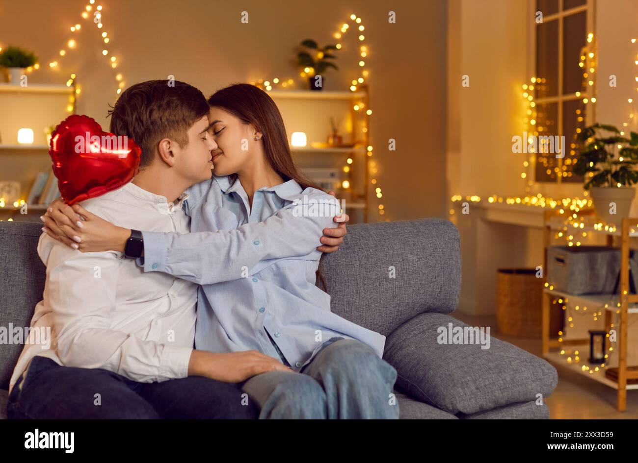 Young Couple Kissing And Embracing With Red Heart On Valentine Day ...