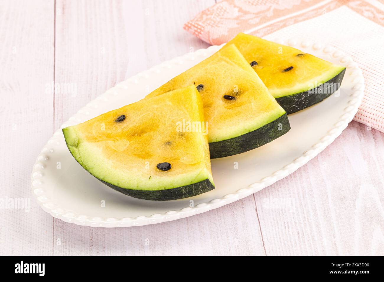 Sweet and juicy yellow watermelon slices in the plate Stock Photo - Alamy
