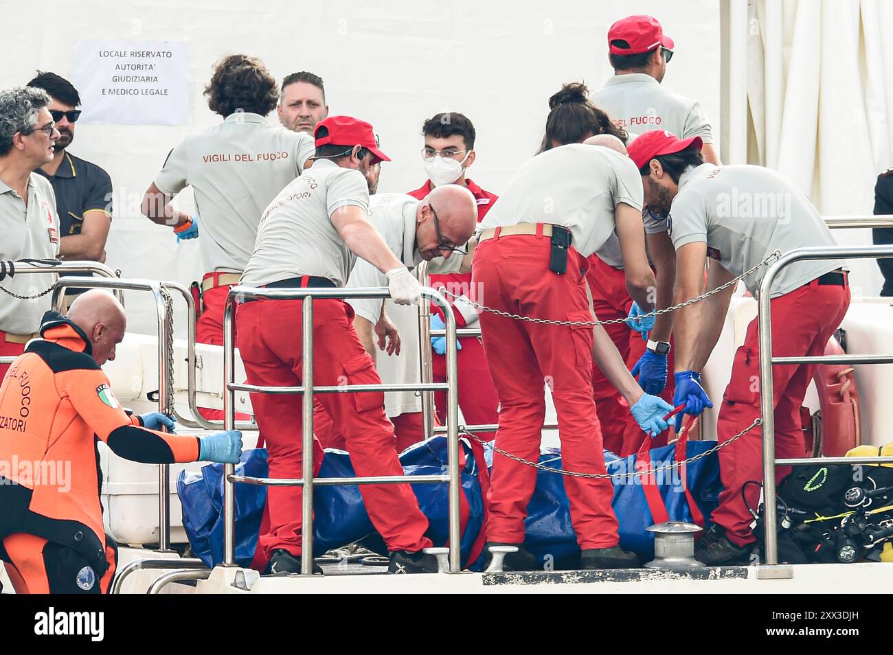 Italian firefighter divers bring ashore in a plastic bag the body of ...