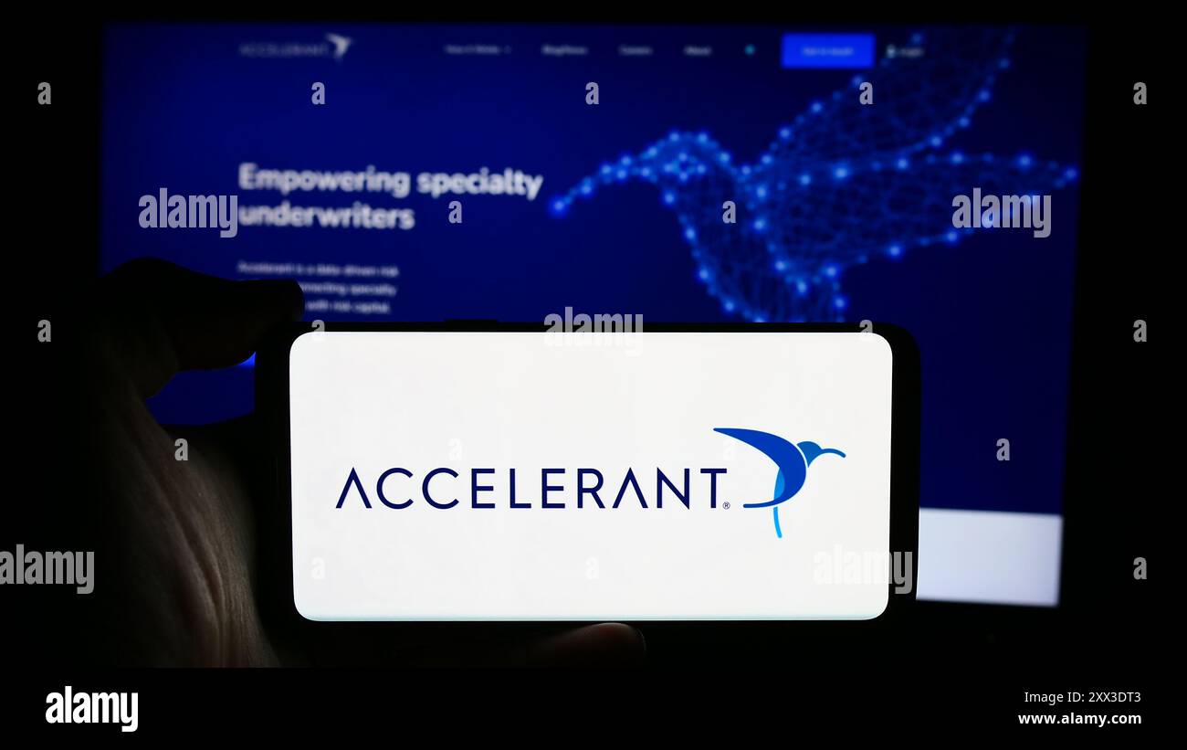 Person holding cellphone with logo of US risk exchange company Accelerant in front of business ...
