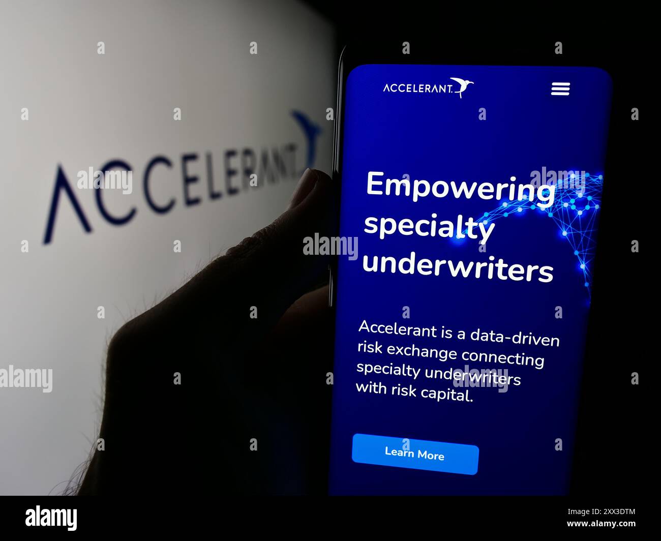 Person holding smartphone with website of US risk exchange company ...