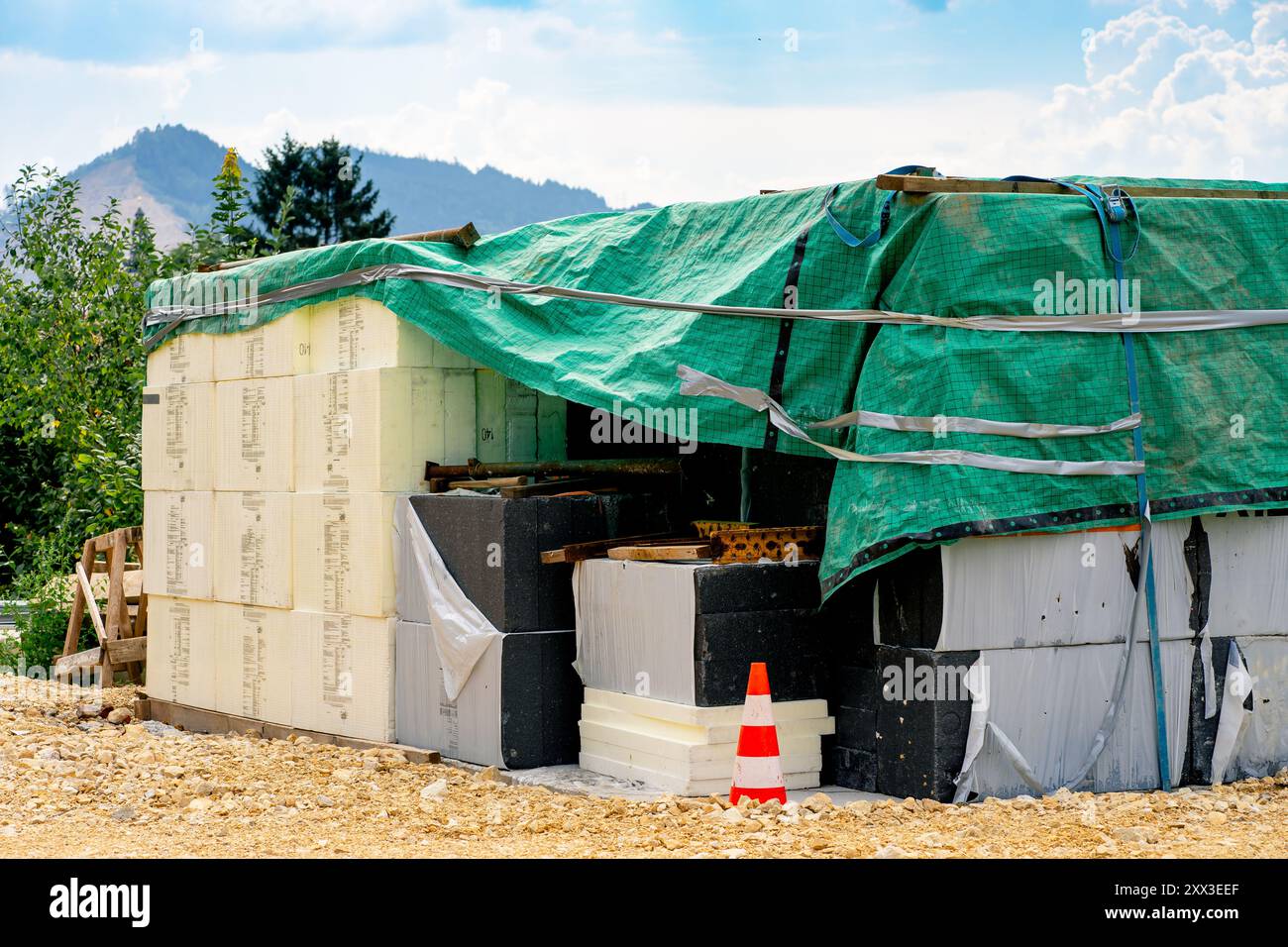 Various building materials and fixtures near a house under construction ...