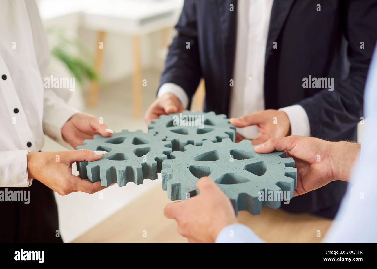 Business people connecting cogs wheel, hands close-up Stock Photo - Alamy