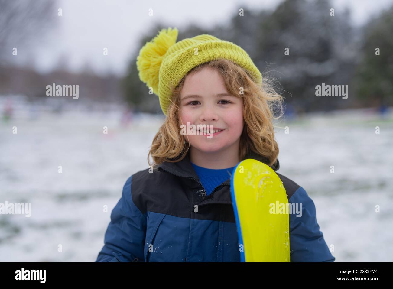 Kid play with snow in winter park. Winter kids with first snow. Child ...
