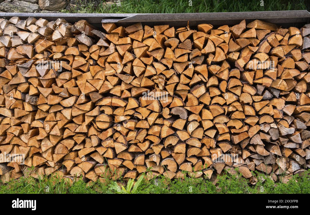 Stacked split logs. Pile of logs ready for winter. Wooden stumps ...