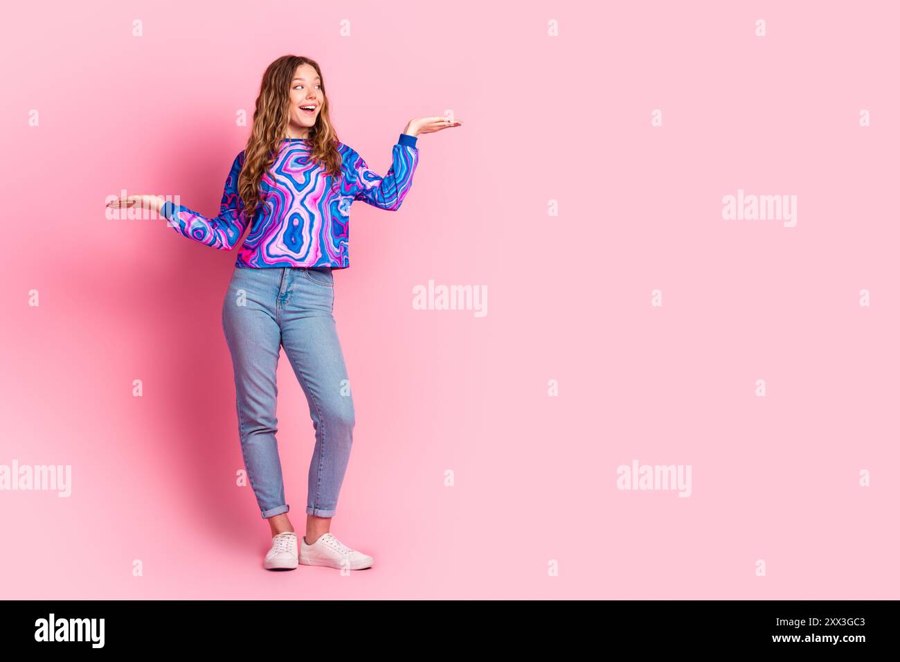 Full body portrait of nice young girl hold empty space wear sweater ...