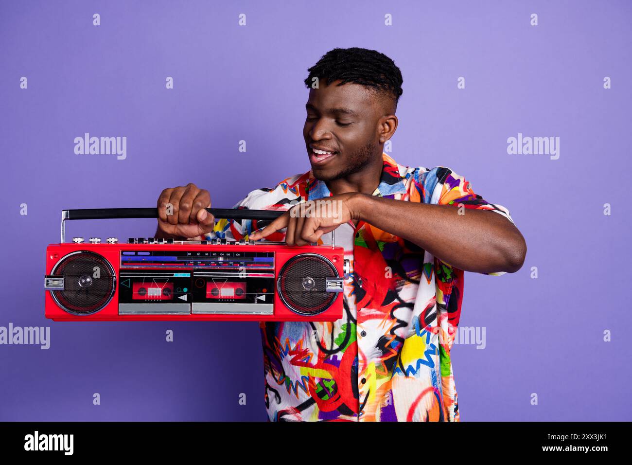 Photo of nice young man press play button boombox isolated on violet ...
