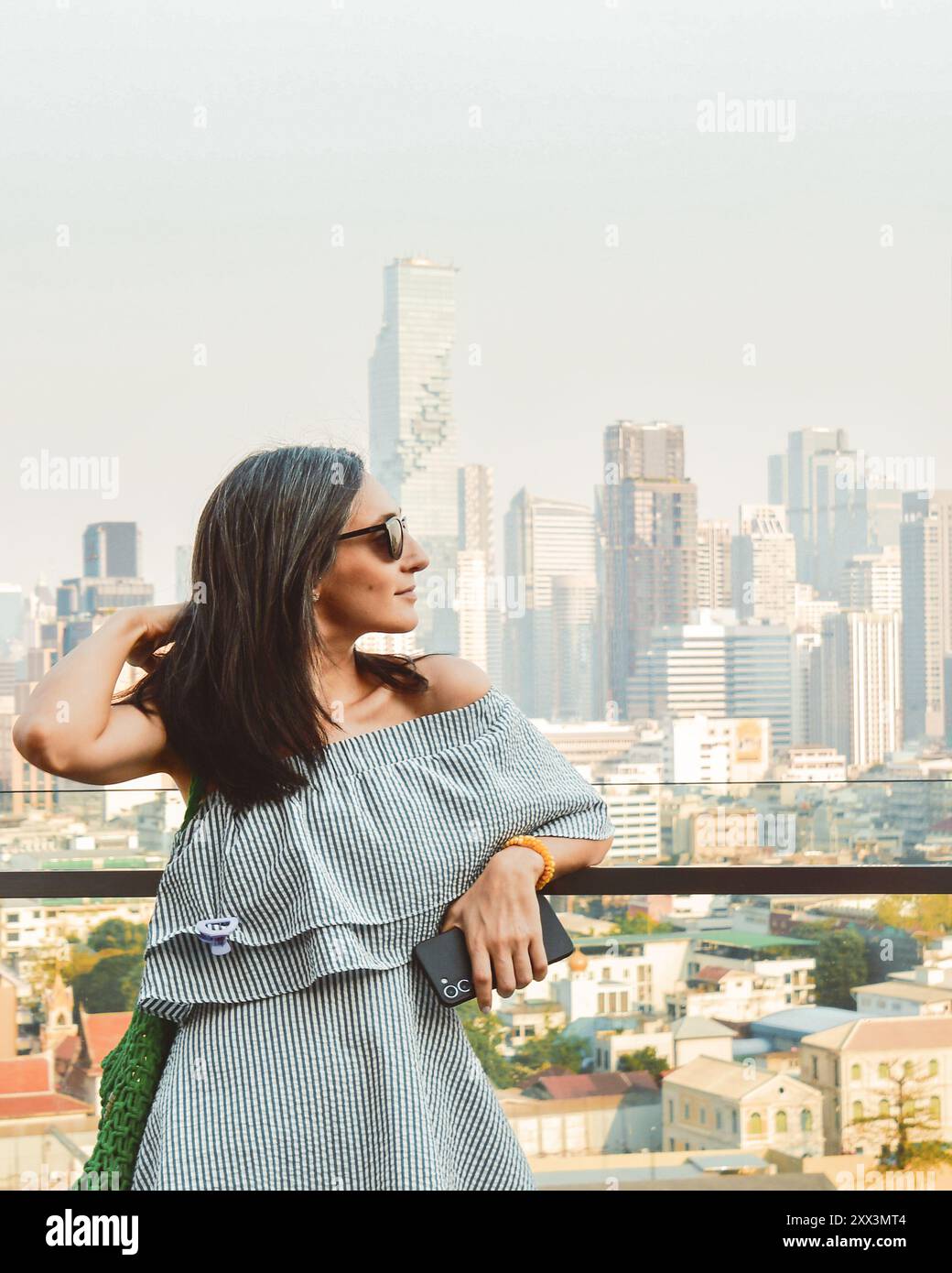 Young pretty woman tourist portrait enjoying Bangkok cityscape skyline ...