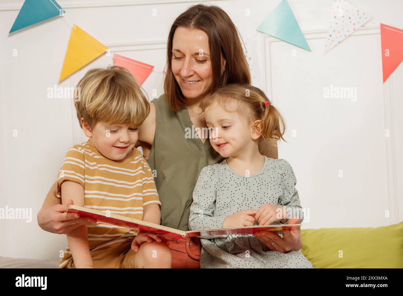 Mom and kids share happy moments of reading stories together Stock ...