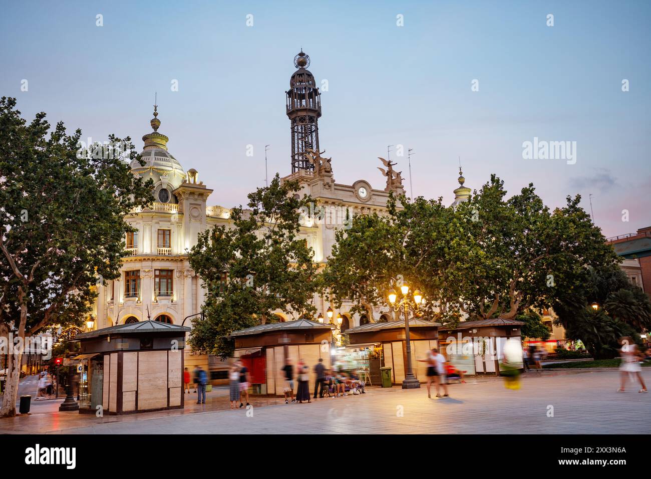 Communication Palace of Valencia shines at dusk, square in front Stock ...