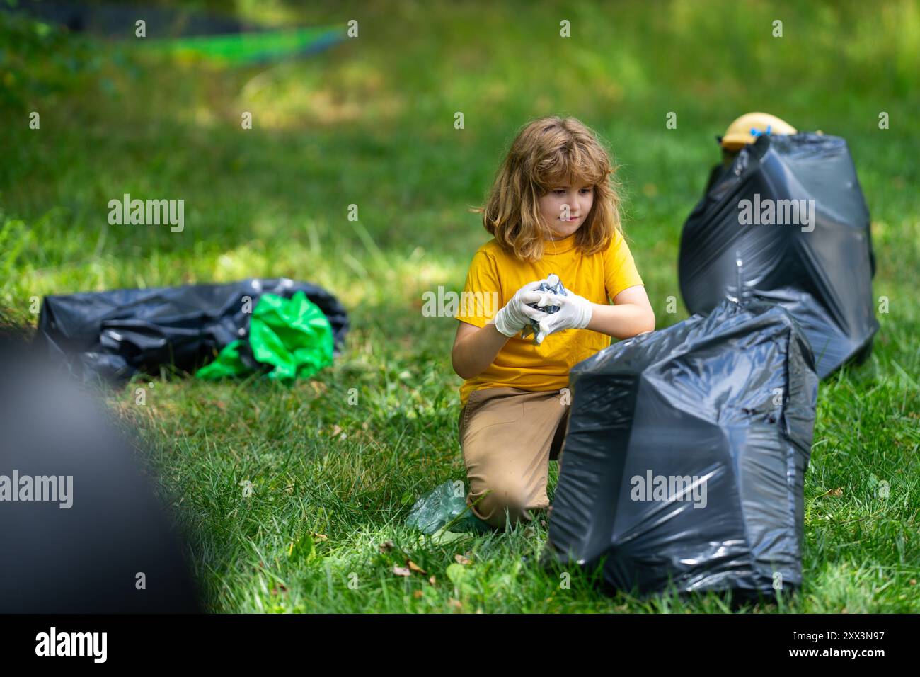 Kid helps to pick up garbage. Pollute forest. Rubbish trash. Planet ...
