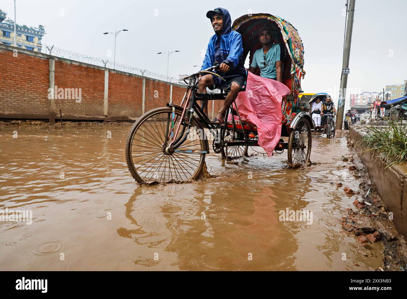 Heavy Monsoon Rain in Dhaka Vehicles and rickshaws are trying to drive with passengers through ...