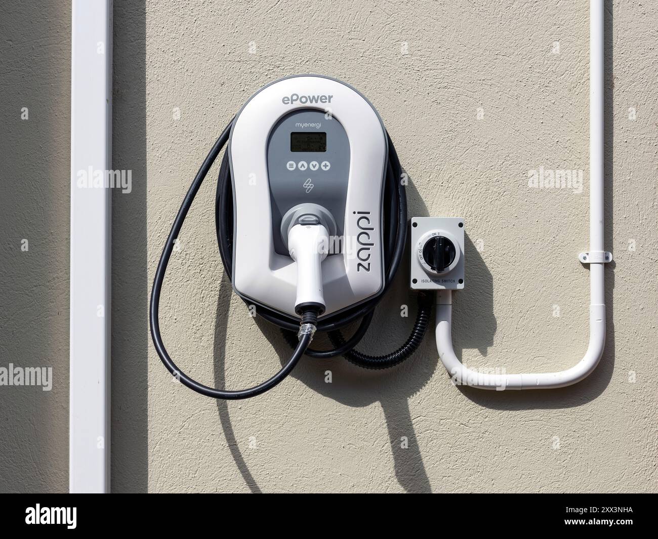 A wall mounted EV charging point installed on the outside a residental ...