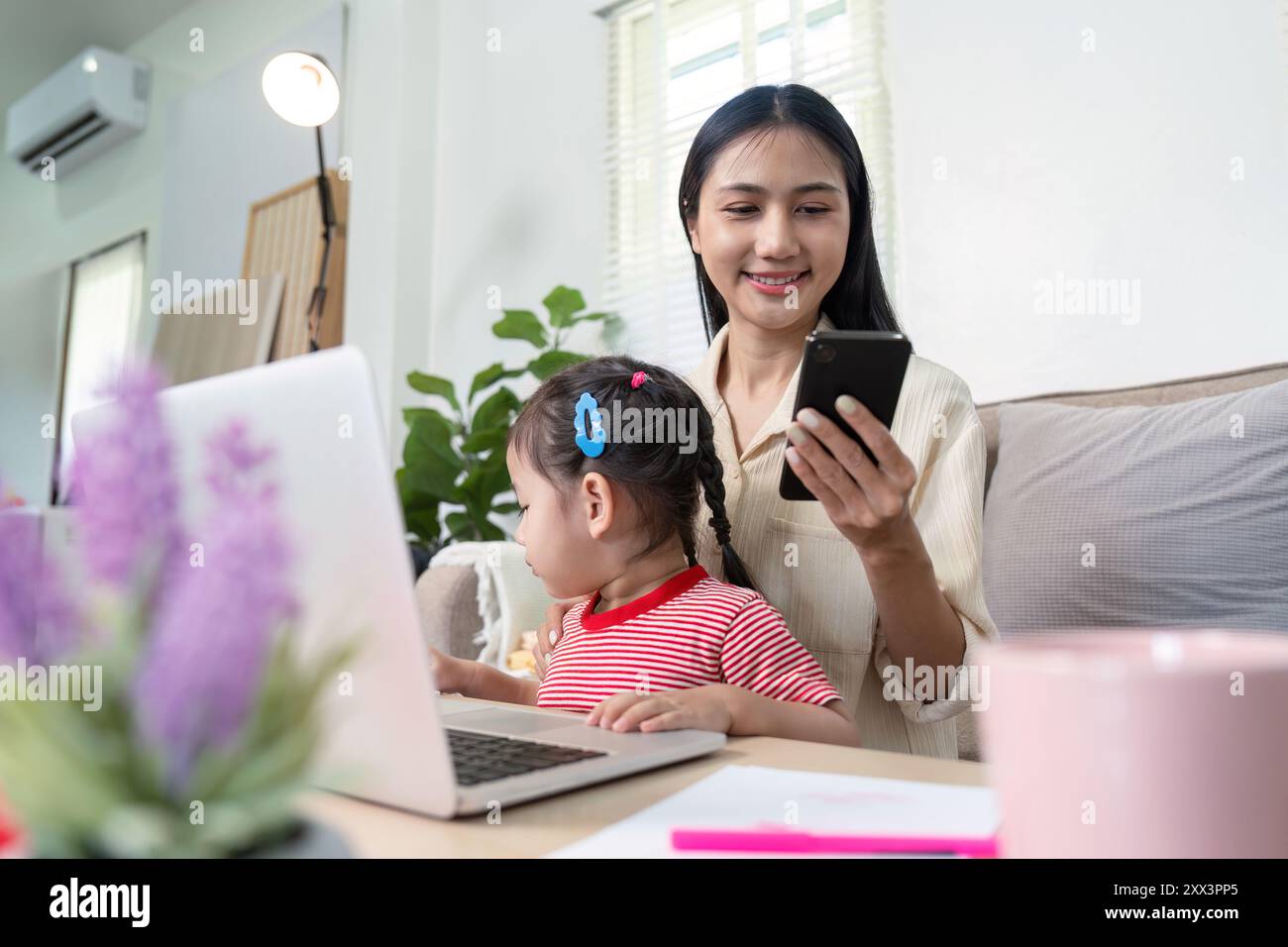 Mother Working from Home with Daughter, Balancing Work and Family Life ...