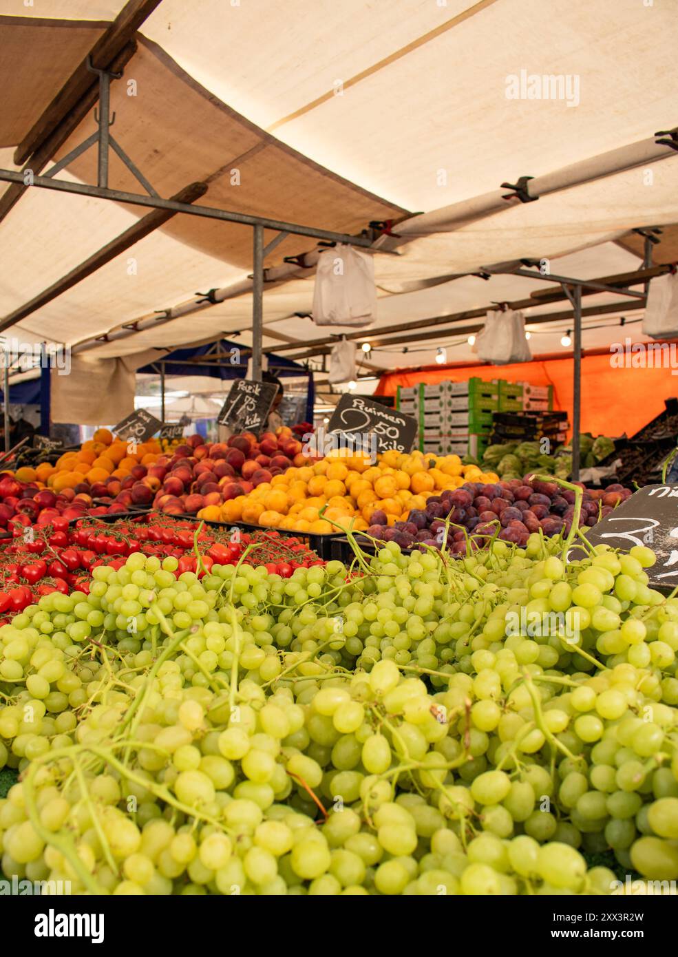 Market stall with white grapes and other fruits. Market stall with ...