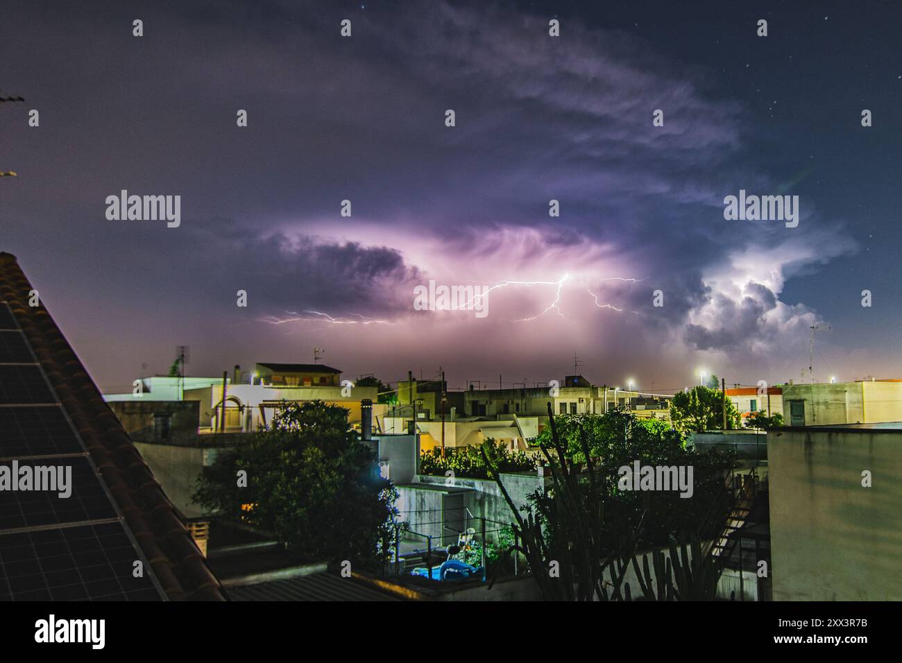 Thunder and lightning of a storm over a city at night Stock Photo - Alamy