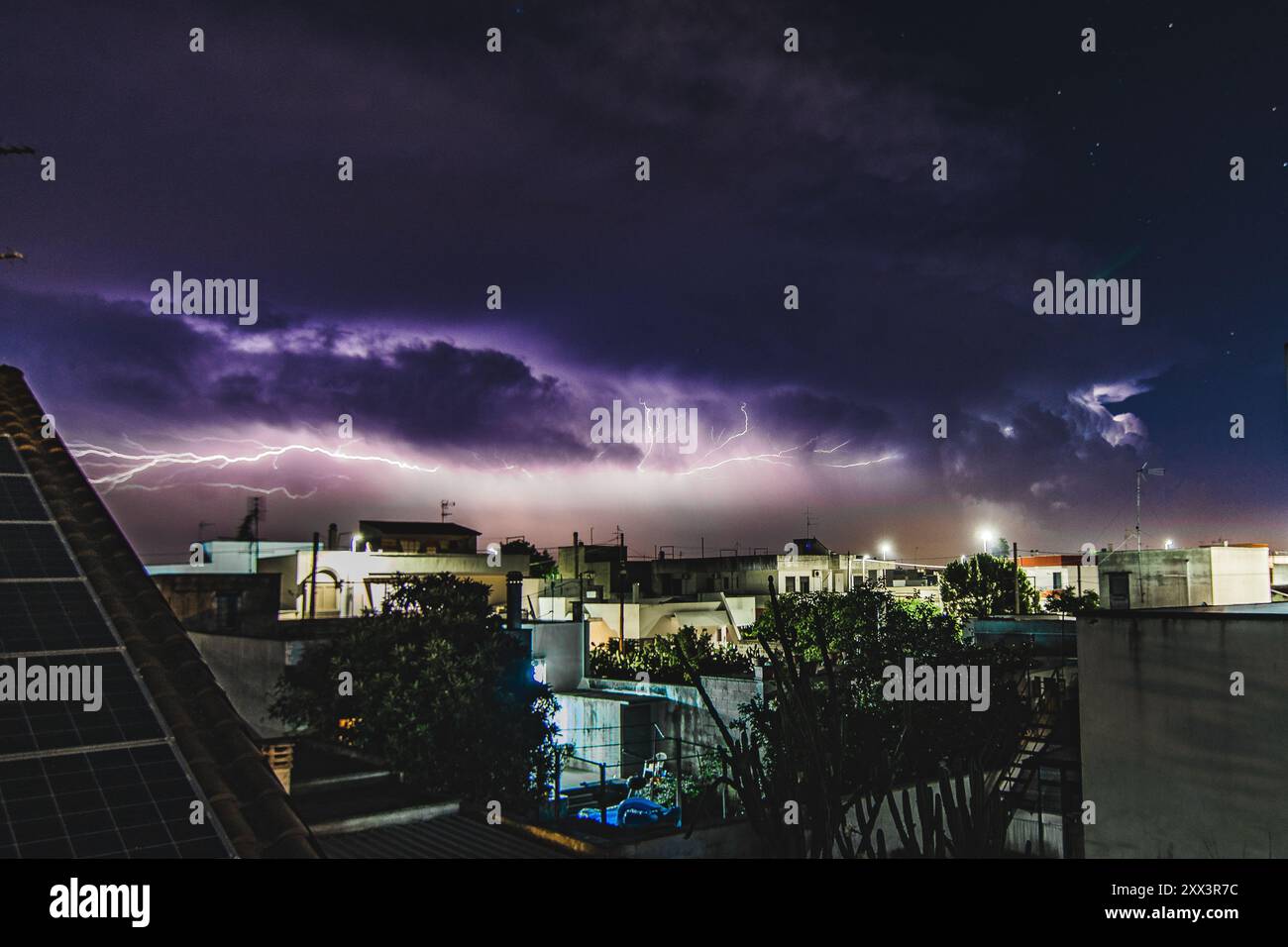 Thunder and lightning of a storm over a city at night Stock Photo - Alamy