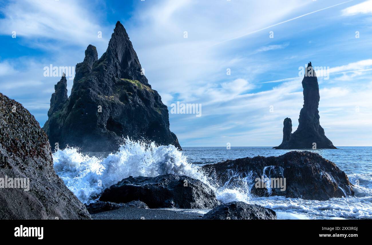 Reynisdrangar spires at Reynisfjara Black Sand Beach, Iceland. A rocky ...