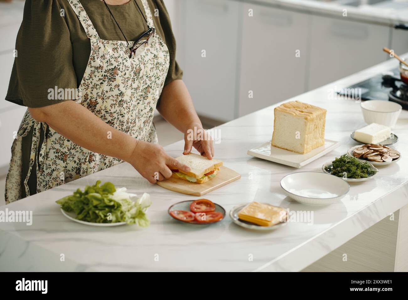 Woman Preparing Sandwich In The Kitchen Stock Photo - Alamy