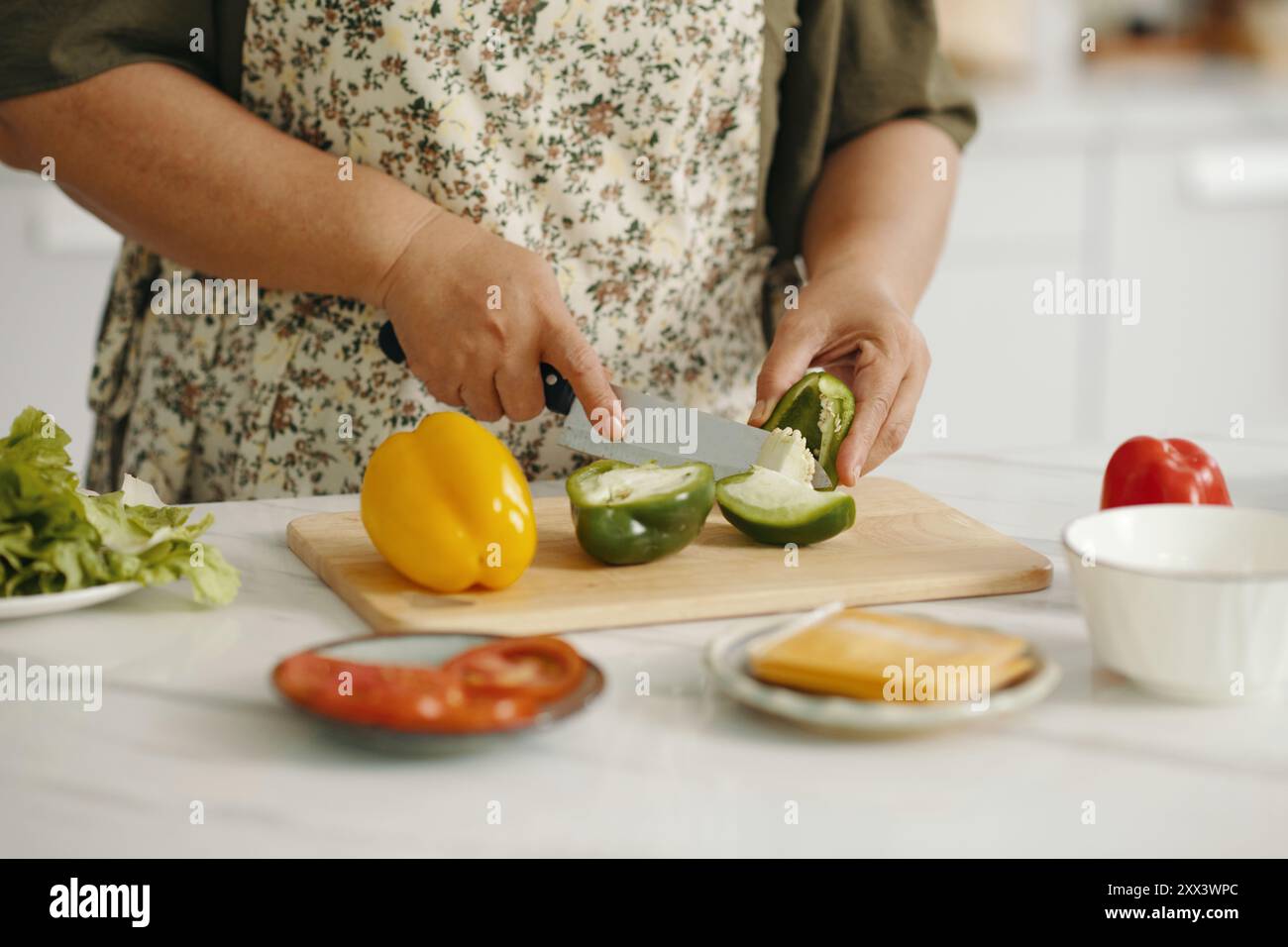 Woman Cutting Vegetables For Salad Stock Photo - Alamy
