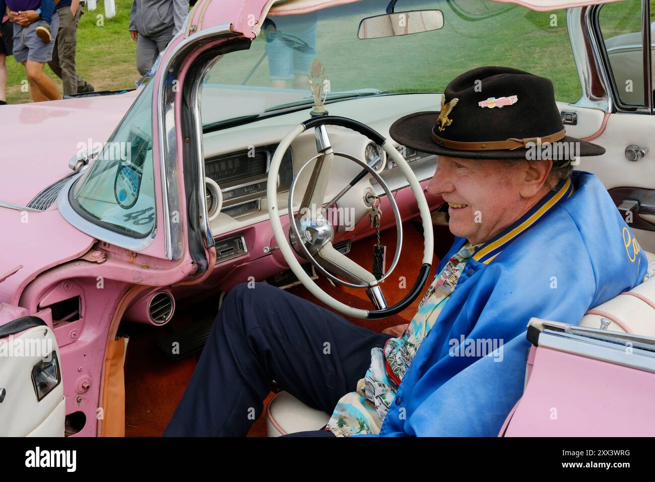 Proud owner sitting in the drivers seat of a Cadillac Parade, The Pink ...