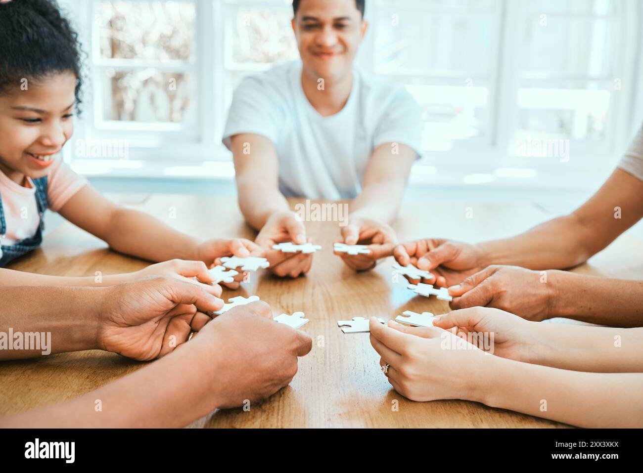 Hands, people and puzzle with collaboration at table for connect piece ...