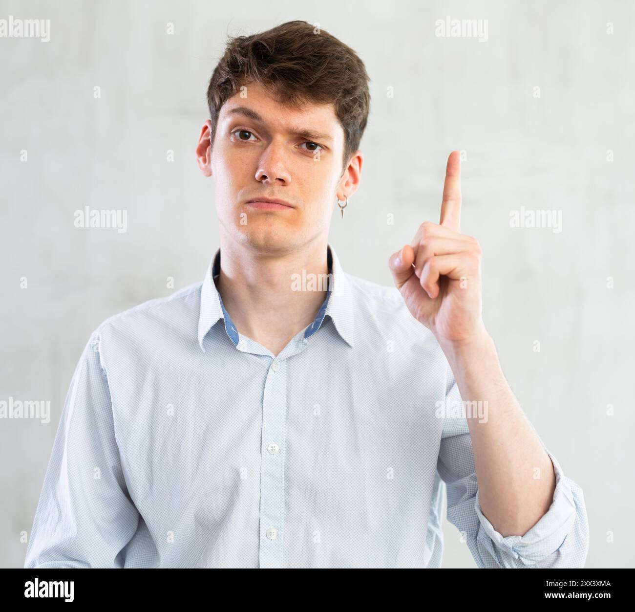 Portrait of young guy gesturing in studio Stock Photo - Alamy