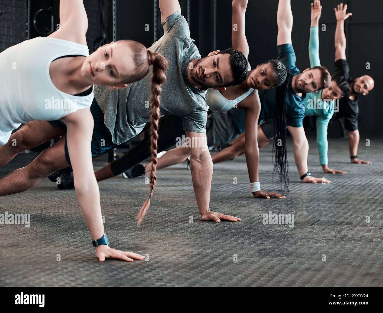 Fitness, side planking and group with instructor, exercise and training ...