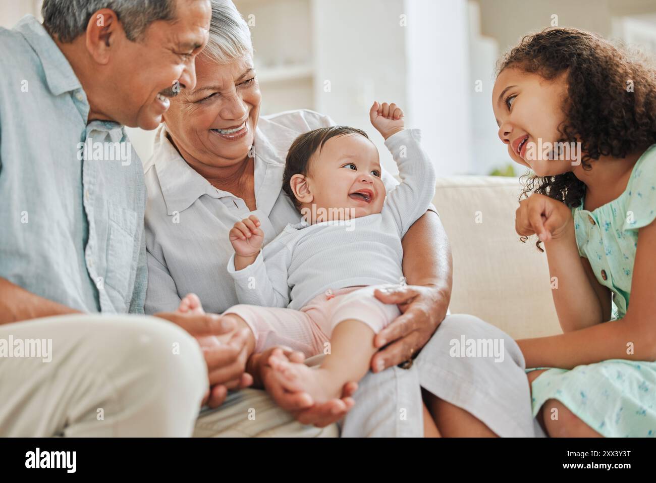 Happy, sofa and grandparents with baby and child in home for bonding, connection or family time ...