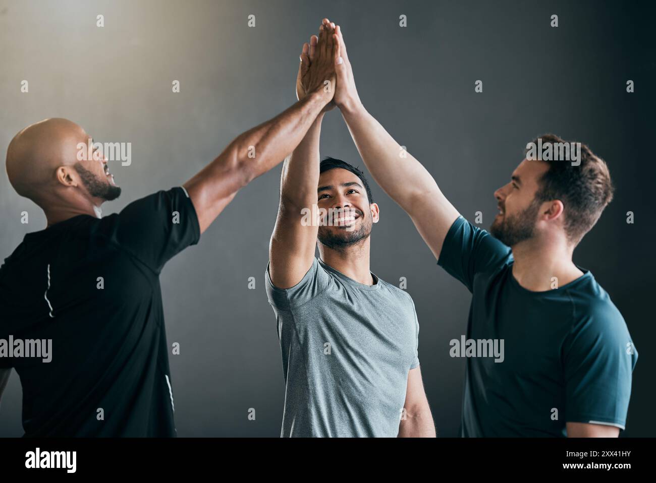 High five, group and athletes in gym for fitness, training or workout ...