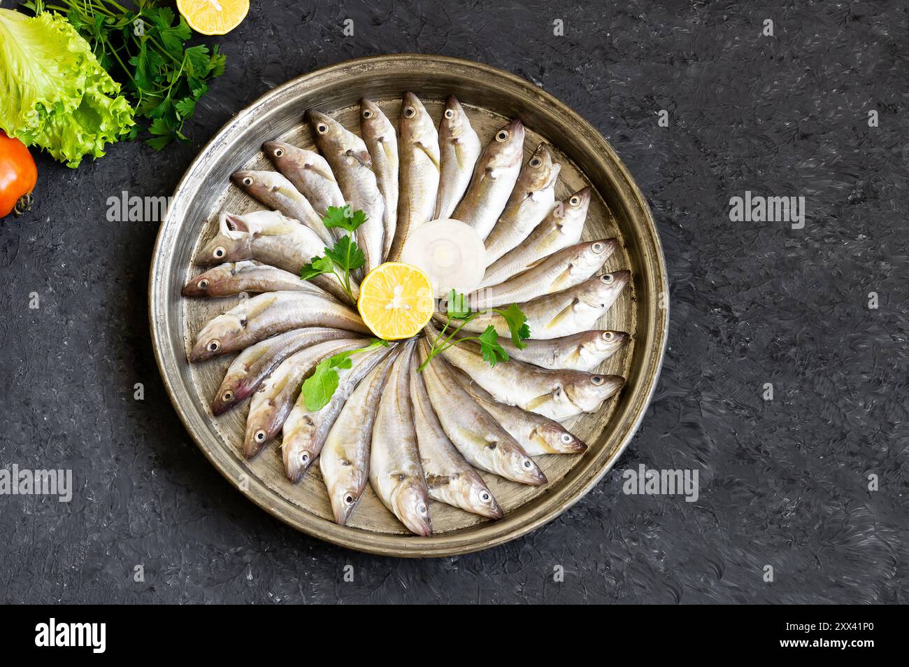 Fresh uncooked haddock fishes on rustic background, raw whiting fish ...