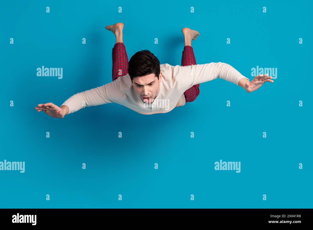 Full length photo of handsome young guy falling down terrified dressed ...