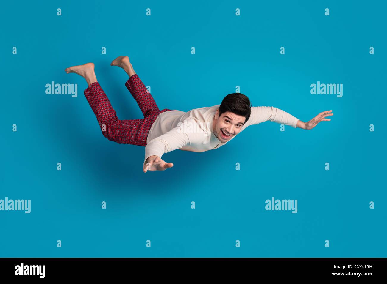 Full body photo of attractive young man flying imagination have fun ...