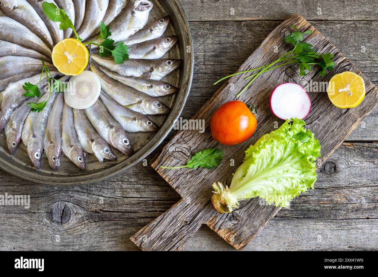 Fresh uncooked haddock fishes on rustic background, raw whiting fish ...
