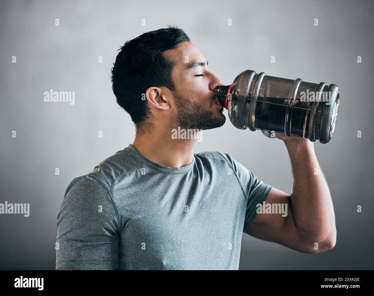 Fitness, man and athlete with drinking water at gym for workout break ...