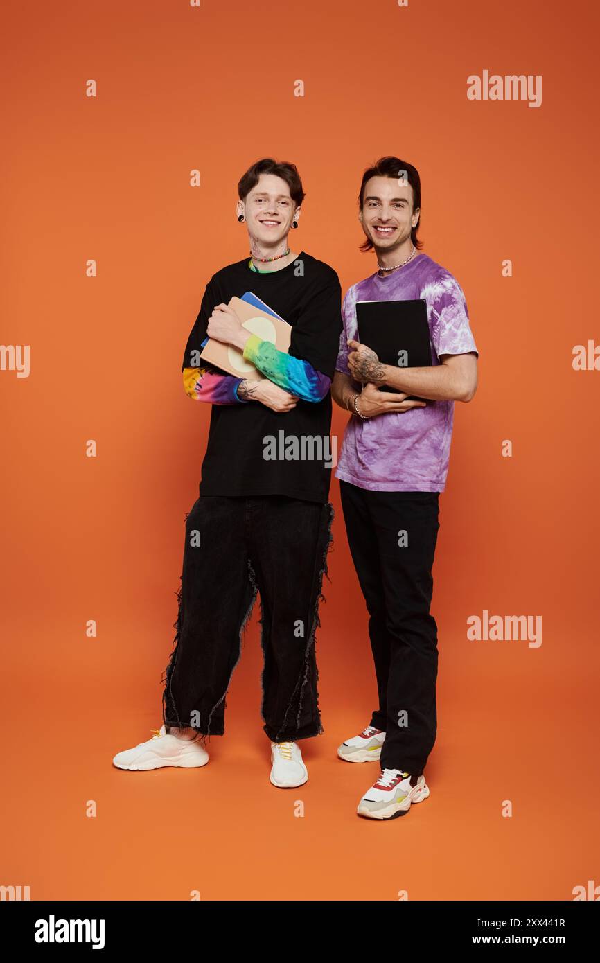 Two young queer friends stand together in stylish and vibrant attire ...