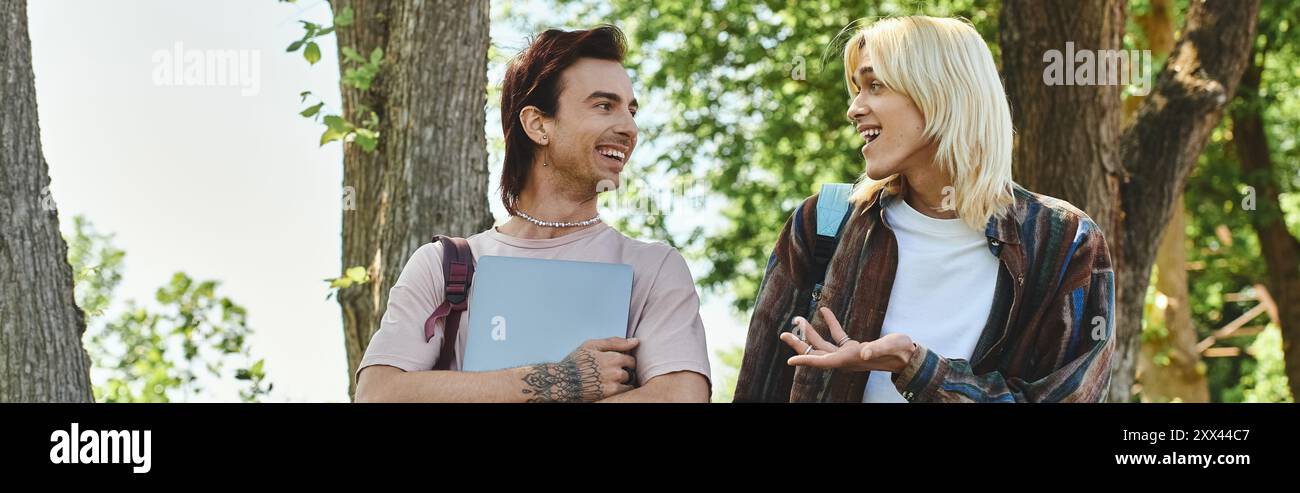 Two young friends, dressed casually, smile and talk to each other on a ...
