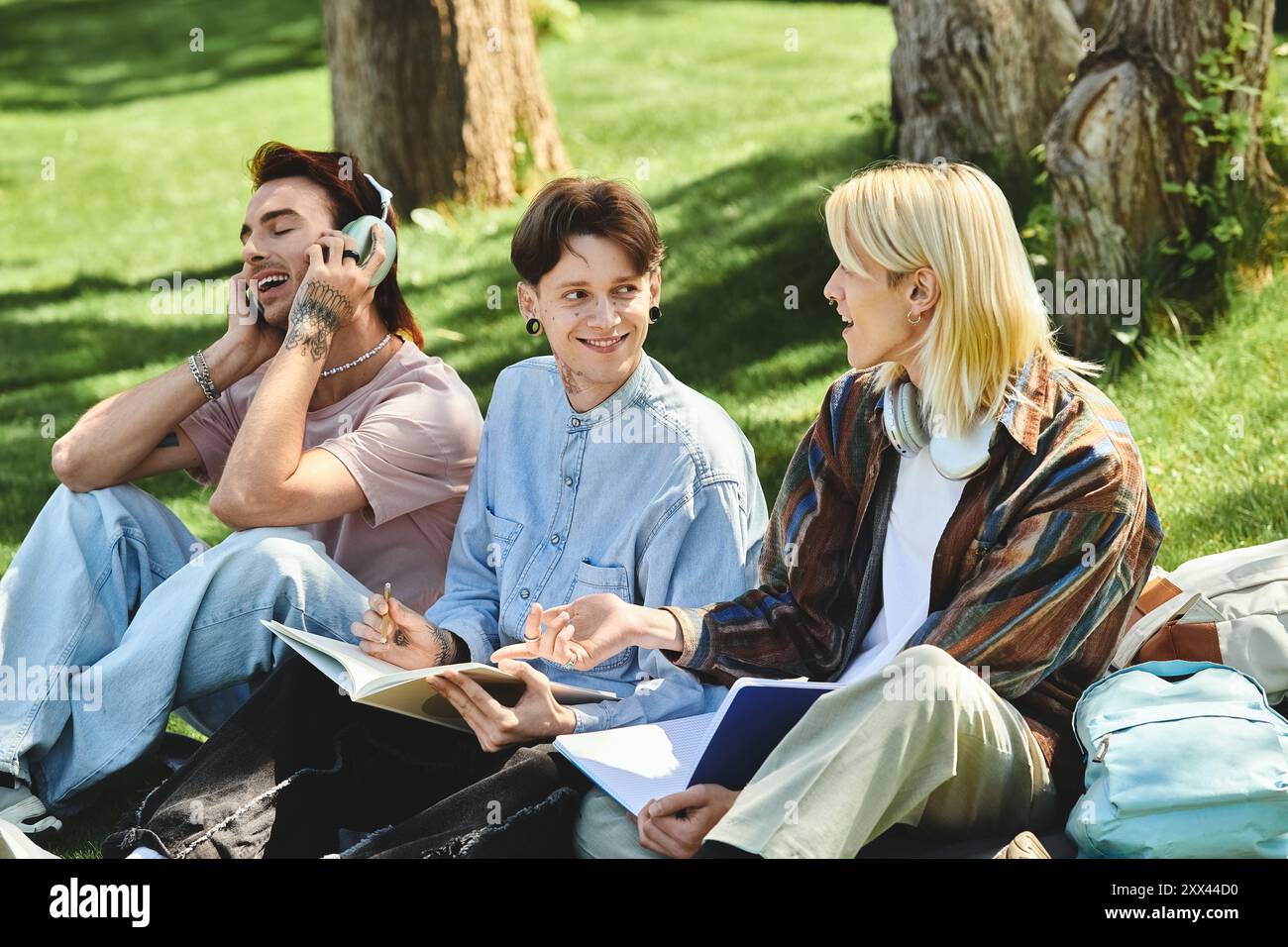 Three young friends, casually dressed, share a moment of laughter and ...