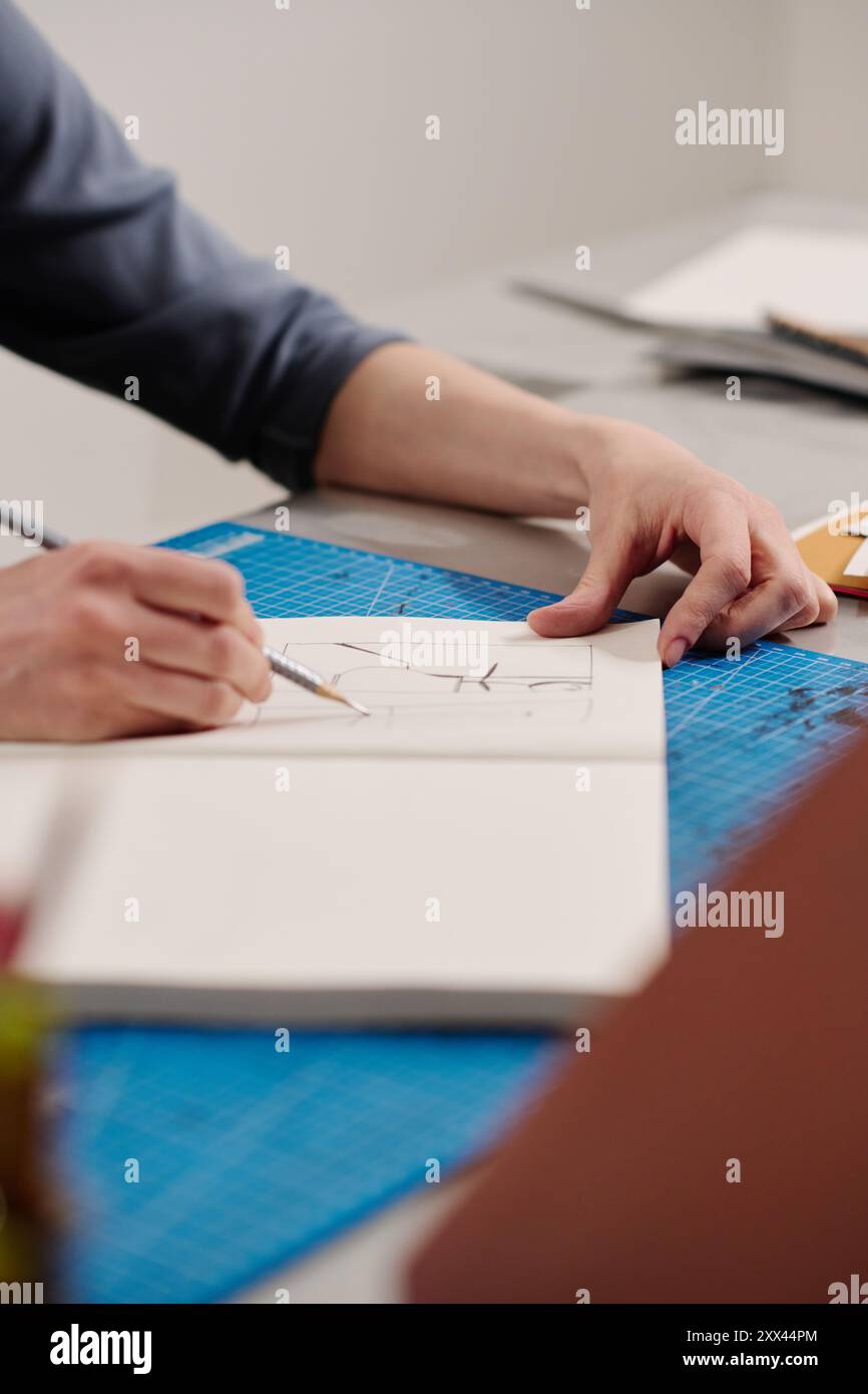 Hands of young unrecognizable female artwork designer with pencil and ...