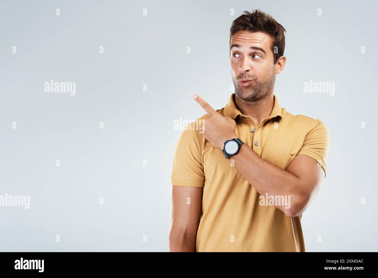 Man, pointing and secret on studio mockup for reveal, promotion and ...