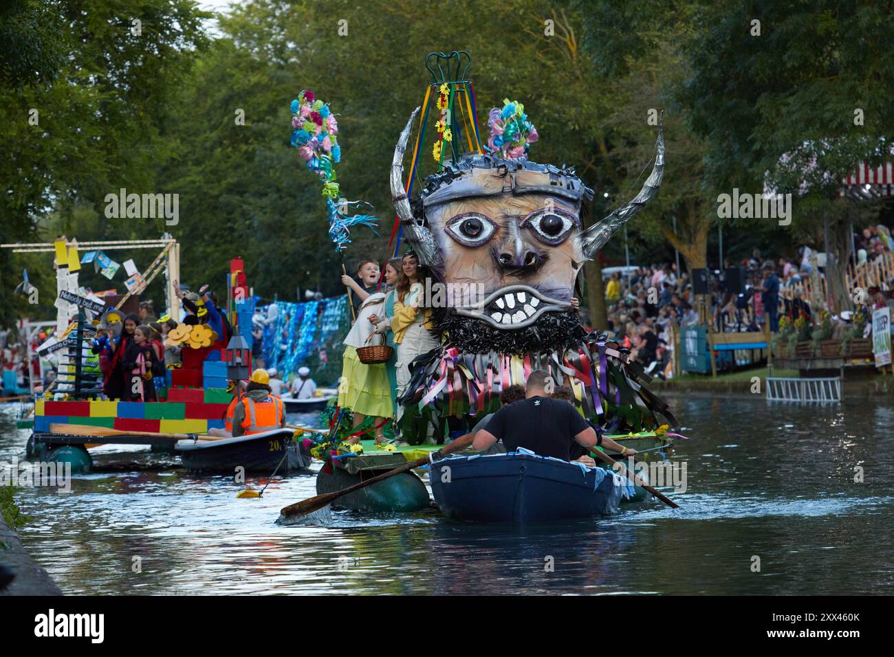 A procession of decorated boats and barges form a floating parade along ...