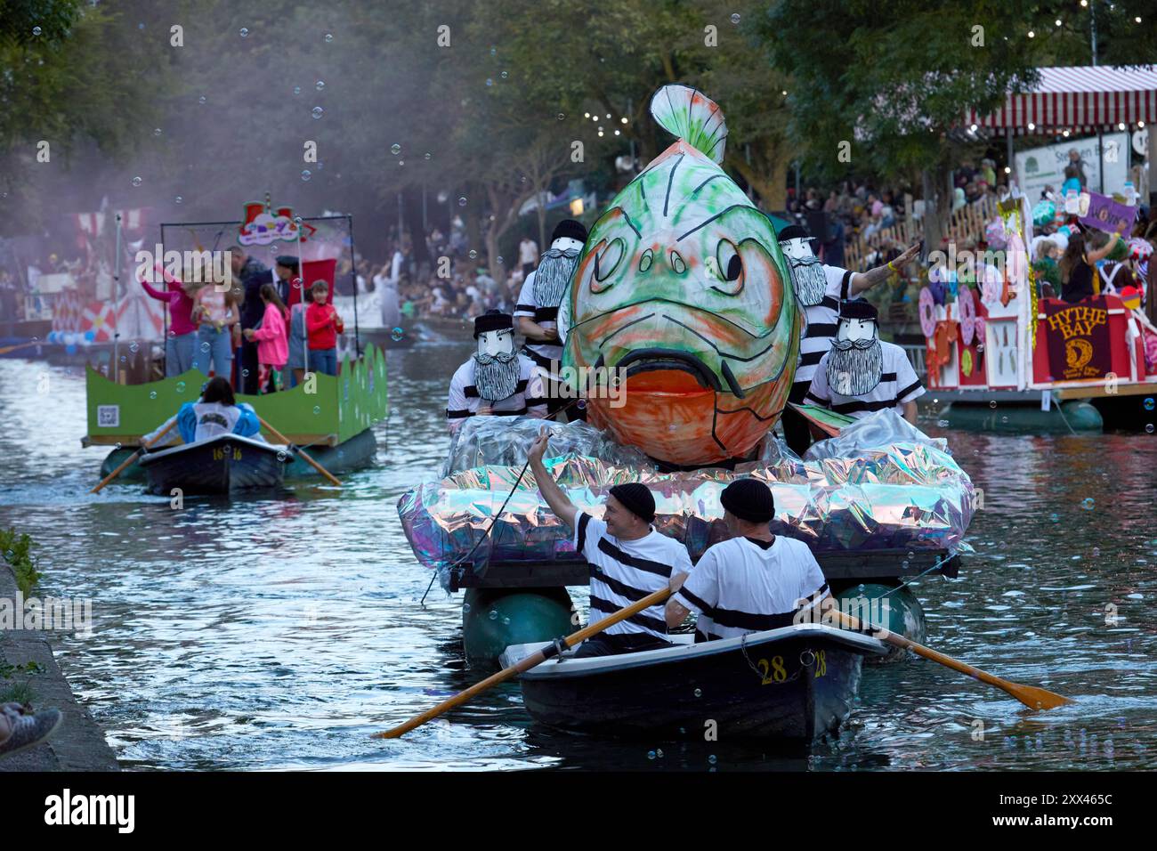 A procession of decorated boats and barges form a floating parade along ...